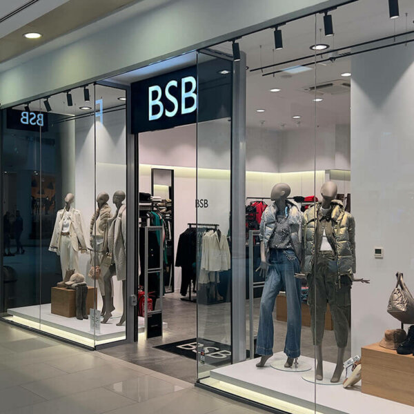 Branding of fashion boutique in mall with illuminated ads